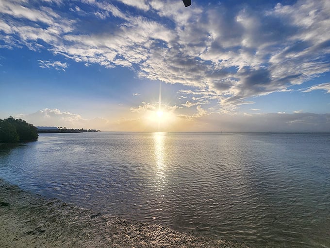 Sunrise at Anne's Beach transforms ordinary water into liquid gold—the kind of wealth you can't deposit but never forget.