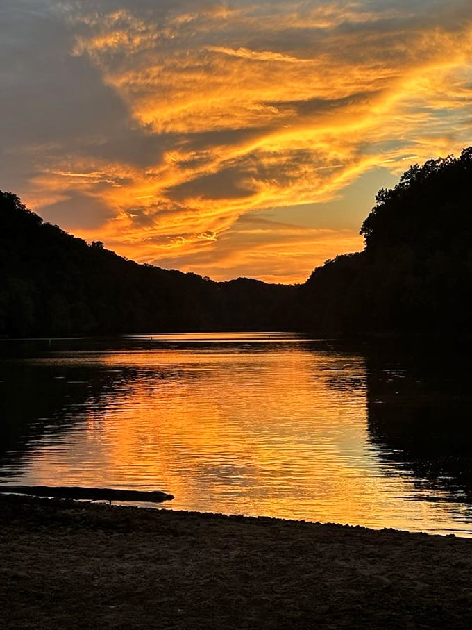 Tennessee sunsets don't just end the day – they celebrate it with a sky painted in impossible oranges reflected perfectly in still waters.