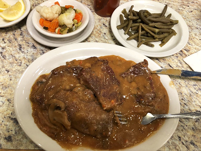 Fork-tender Swiss steak swimming in rich gravy—the kind of dish grandmothers everywhere would approve of with a knowing nod.