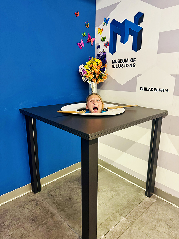 "Mom, I've lost my head!" The classic head-on-a-platter illusion gets a modern twist with a cheerful youngster serving up some family-friendly horror.