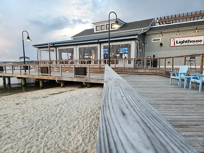 The Lighthouse restaurant extends over sand like a dining room that couldn't decide between beach and bay views.