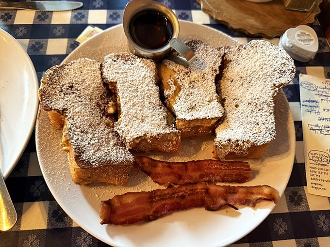 French toast that's dressed for success. Powdered sugar snowfall, crisp bacon sidekicks, and a puddle of syrup waiting to make your morning magical.