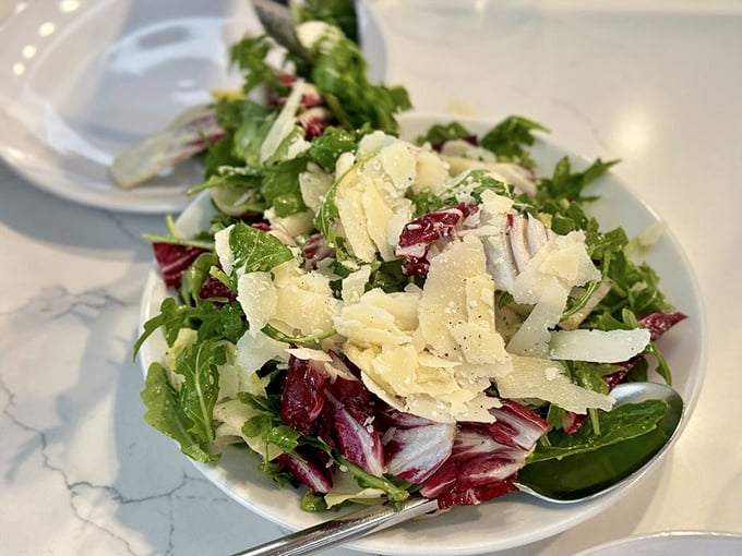 A salad that actually excites—crisp greens, shaved cheese, and the promise that vegetables can indeed be the main event.
