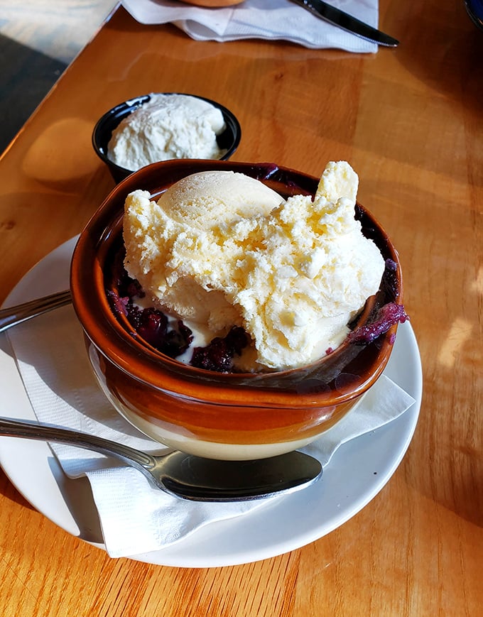 The triple berry cobbler doesn't just end your meal—it provides the kind of warm, fruity closure therapists should prescribe for anxiety.