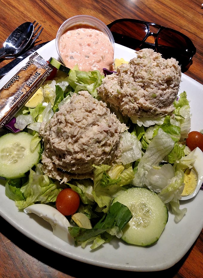 Garden-fresh tuna salad served atop crisp lettuce with a side of thousand island dressing – proof that "diet food" doesn't have to taste like punishment.