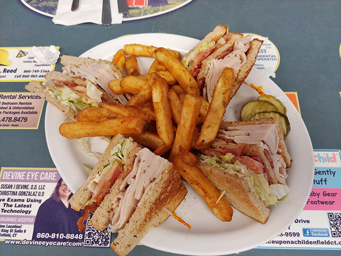 The architectural marvel known as a club sandwich—layers of turkey, crisp vegetables, and toast secured with those fancy toothpicks that make you feel sophisticated.