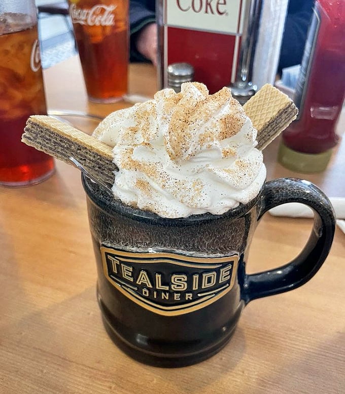 Coffee elevated to an art form—whipped cream mountain, wafer cookies standing tall, and just enough cinnamon to make your taste buds do a happy dance.