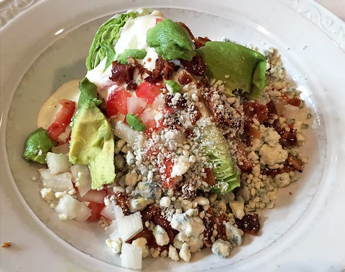 A wedge salad that actually makes vegetables exciting—blue cheese, bacon, and avocado forming a triumvirate of taste worth celebrating.