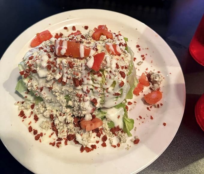Even the wedge salad gets the royal treatment—a throne of iceberg crowned with blue cheese crumbles and bacon bits fit for Midwest royalty.