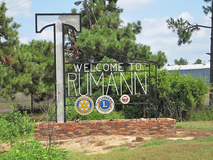 The "T" welcomes you to Trumann with civic pride – where Rotary and Lions Club emblems signal the community spirit that keeps small towns thriving.