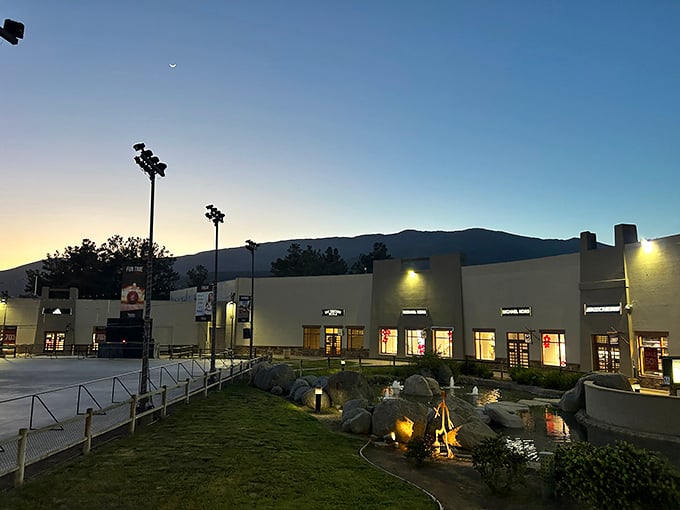 As twilight falls, the outlet center glows with possibility – and the knowledge that nighttime shopping burns just as many calories.