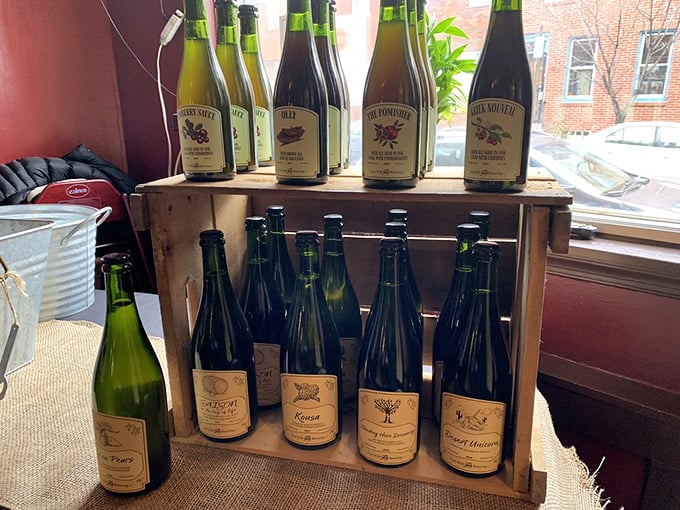 A thoughtful selection of craft beverages displayed in rustic wooden crates – because great barbecue deserves worthy liquid companions.