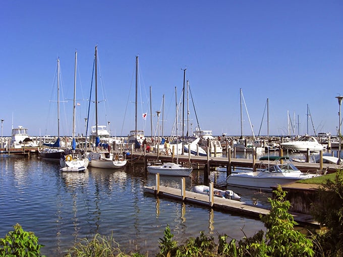 Rustic buildings huddle around crystal waters like old friends sharing secrets across the generations of visitors.