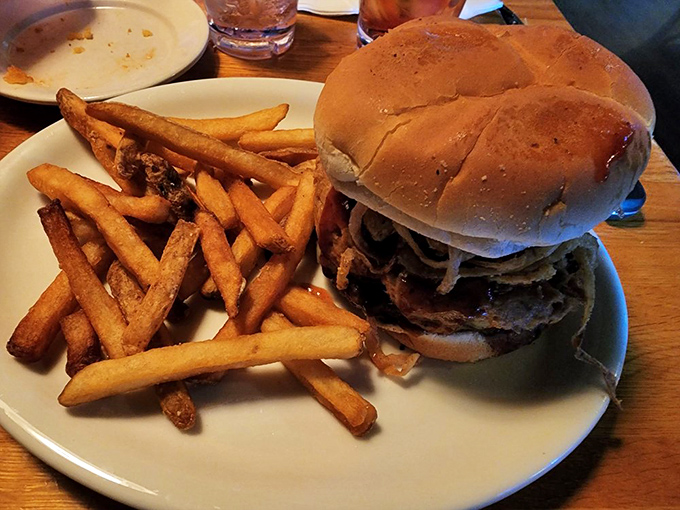 A burger that requires both hands and a strategy—the kind of meal that makes conversation impossible until you've conquered at least half of it.
