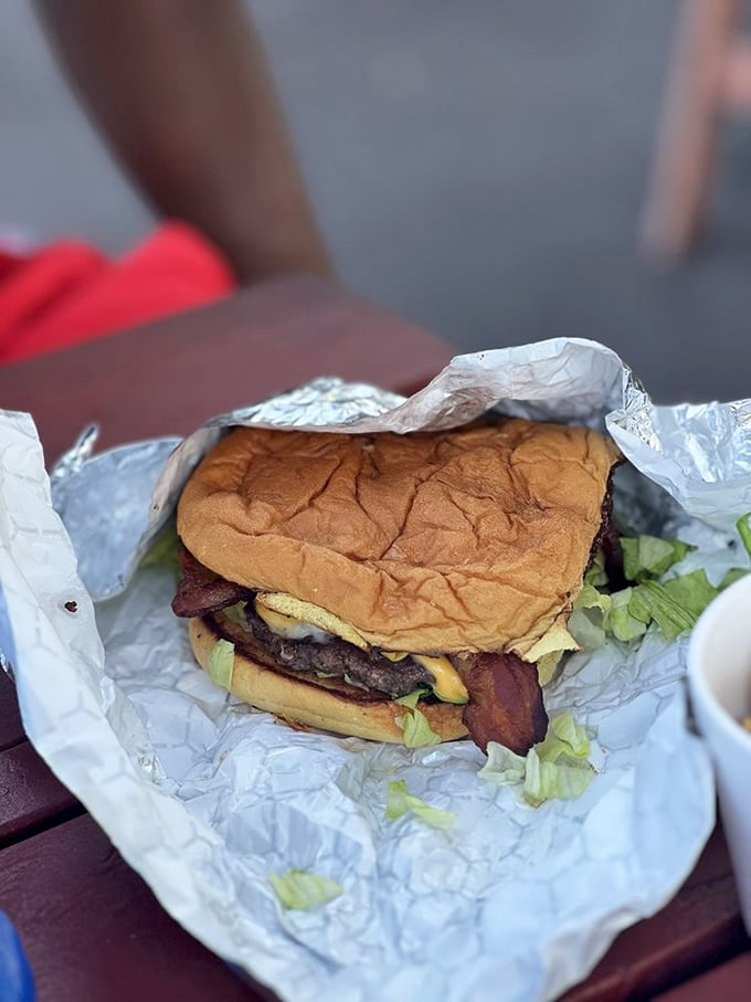 This isn't just a burger—it's a towering achievement of beef, bacon, and toppings that makes you wonder if you should eat it or frame it.