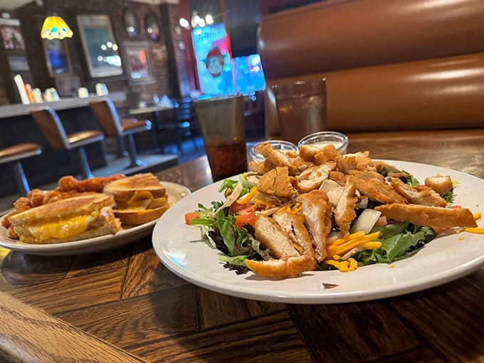 A chicken salad that doesn't apologize for being exactly what it is—generous, colorful, and completely devoid of pretension. The sandwich in the background is plotting to steal your heart.