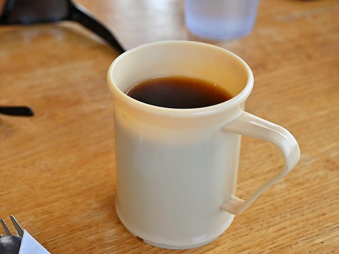 The humble coffee mug – unassuming vessel of morning salvation. No fancy latte art, just honest caffeine in its natural habitat.