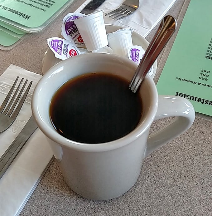 The humble diner coffee mug—civilization's most important vessel, delivering life-giving caffeine with no pretension, just honest warmth and refills.