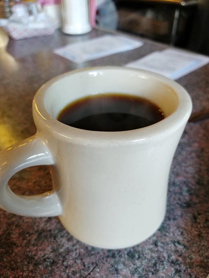This isn't just coffee – it's liquid resilience in a sturdy white mug, ready to resurrect you from whatever French Quarter adventures transpired the night before.