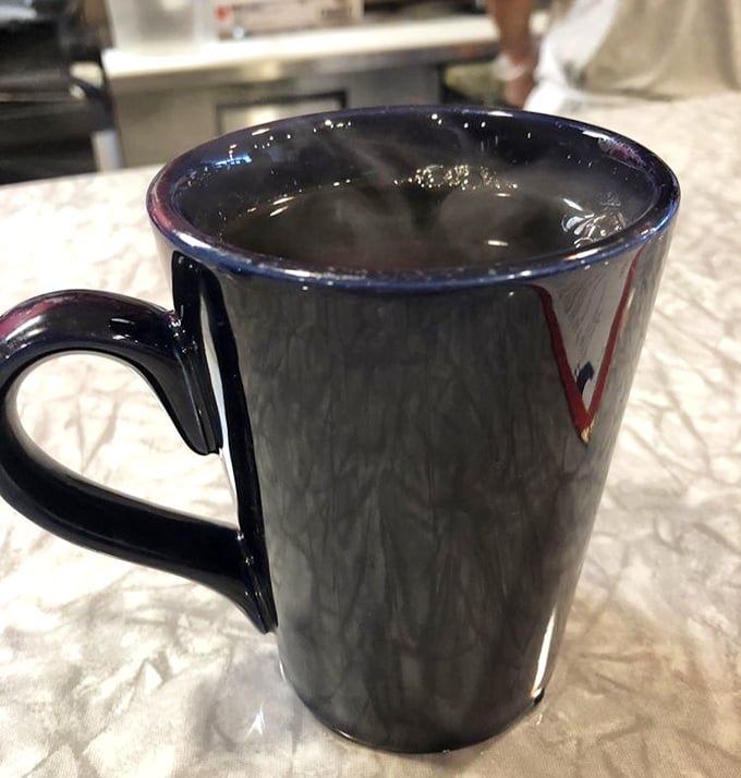 That navy blue mug isn't just holding coffee; it's cradling liquid ambition, morning motivation, and possibly the solution to all of life's problems.