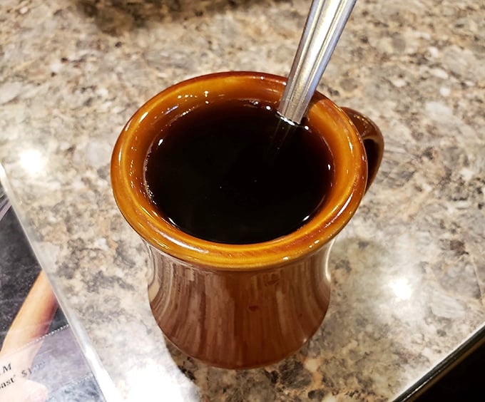 Diner coffee in a proper mug—dark as midnight, hot as sin, and essential as oxygen for starting the day right.