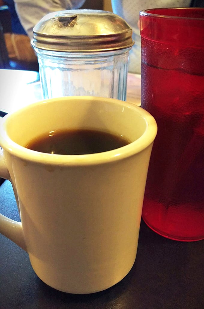 The humble diner coffee mug—steadfast companion to countless conversations, confessions, and contemplations. No fancy latte art needed here.