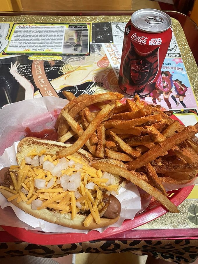 The perfect trifecta: a classic dog with cheese and onions, golden fries, and a soda. Some relationships are just meant to be.