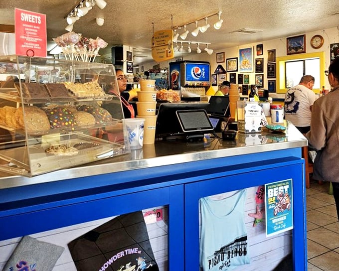 The counter area doubles as a museum of satisfied customers, where desserts tempt you before you've finished your main course—a delicious dilemma.