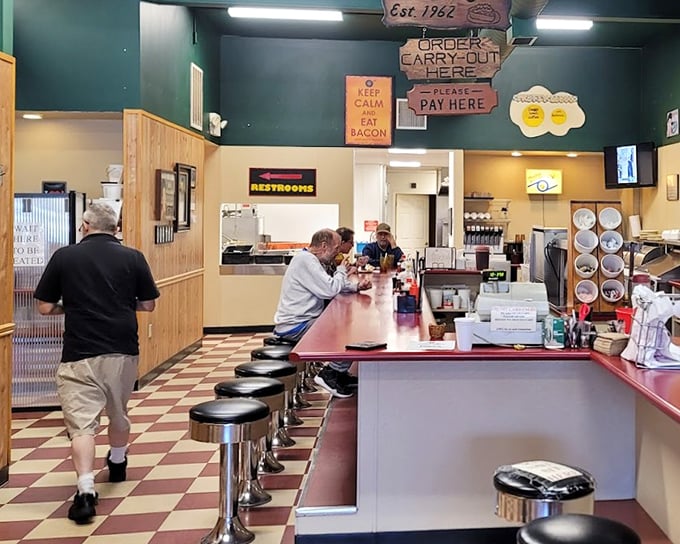 The counter seating—where breakfast magic happens in full view. Those stools have supported thousands of happy customers contemplating a second coffee refill.
