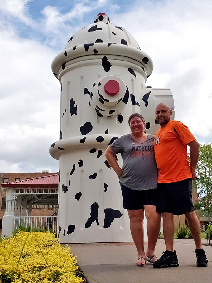 Happy visitors prove that giant fire hydrants bring out the kid in everyone, regardless of age.