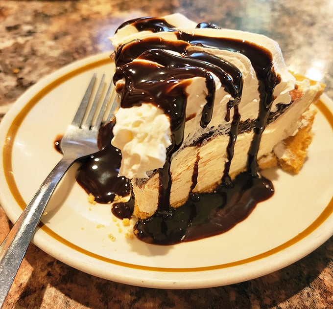 Pie that doesn't need Instagram filters—just chocolate sauce cascading down creamy layers that make diets seem like terrible life choices.