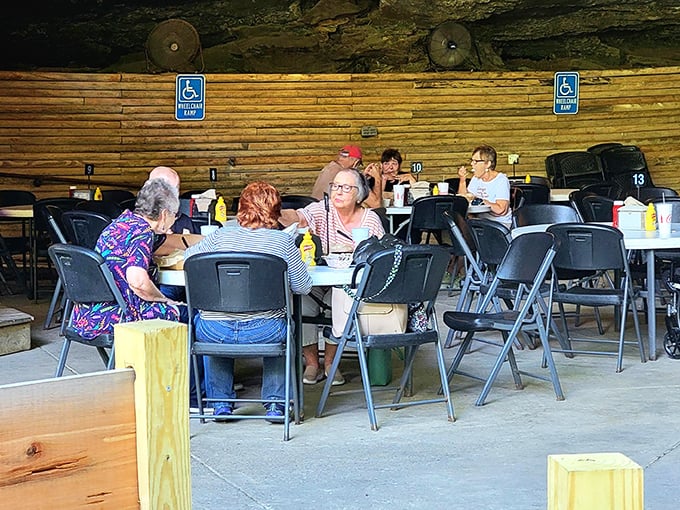 Even under a massive rock, social connections flourish. These diners prove that breaking bread together is humanity's oldest and most reliable form of entertainment.