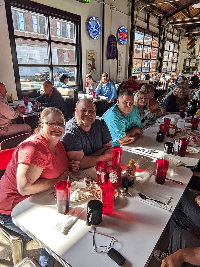 Where strangers become regulars and regulars become family. Red Coca-Cola glasses mark the tables like ruby beacons of hospitality.