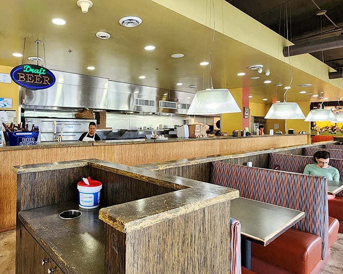 The open kitchen design isn't just practical – it's dinner theater where spatula-wielding artists perform their craft before an appreciative audience.