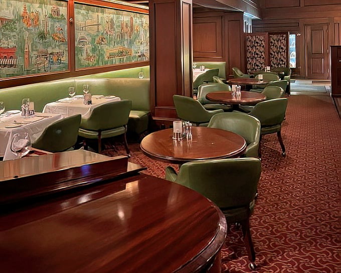 The lounge area offers a more casual vibe with plush green chairs and warm wood tones – like your wealthy uncle's study, but with better food.