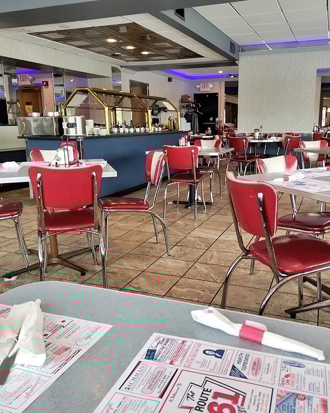 The dining area balances retro charm with comfortable spaciousness, those blue accent lights adding a touch of modern flair.