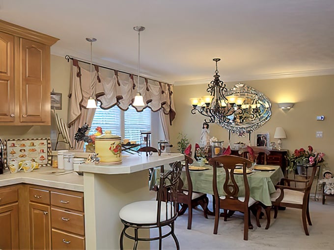 Dining areas that seamlessly connect to kitchens—because the best conversations happen when food preparation and enjoyment share the same space.