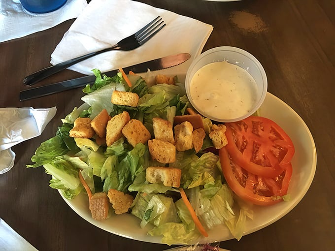 A dinner salad that doesn't apologize for being healthy – fresh greens, vibrant tomatoes, and homemade croutons that crunch like autumn leaves.