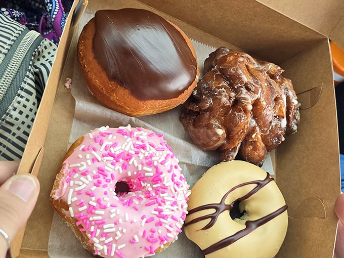 Donuts that would make Homer Simpson abandon Springfield. That chocolate-topped beauty isn't just a pastry—it's an edible work of art.