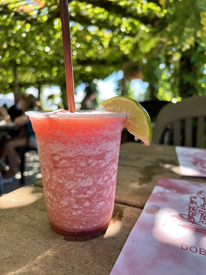 Summer in a glass! This frosty strawberry concoction under vine-dappled sunlight is what vacation memories are made of.