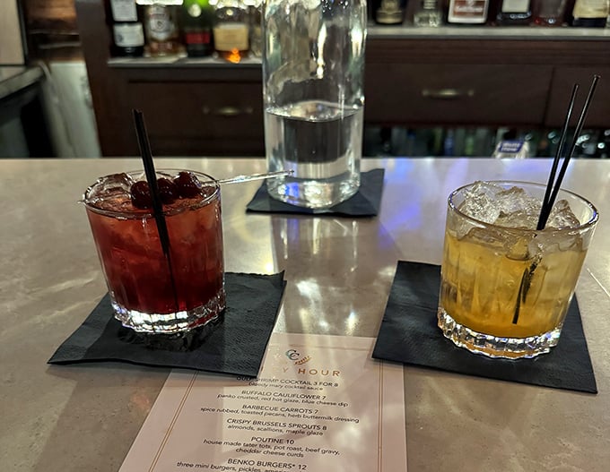 Craft cocktails that double as liquid artwork – one ruby red, one amber gold – waiting to complement whatever culinary adventure you choose.