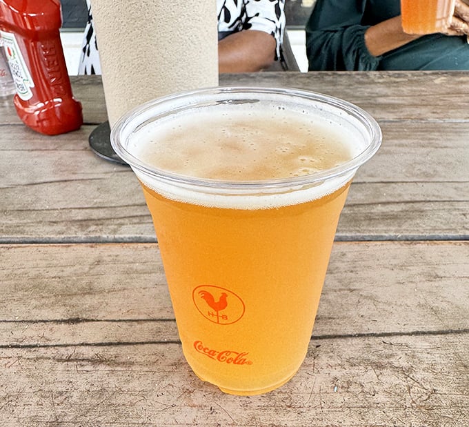 Nothing tames the fire of hot chicken like a cold, crisp beer sporting the Hattie B's logo—it's not just refreshment, it's survival equipment.