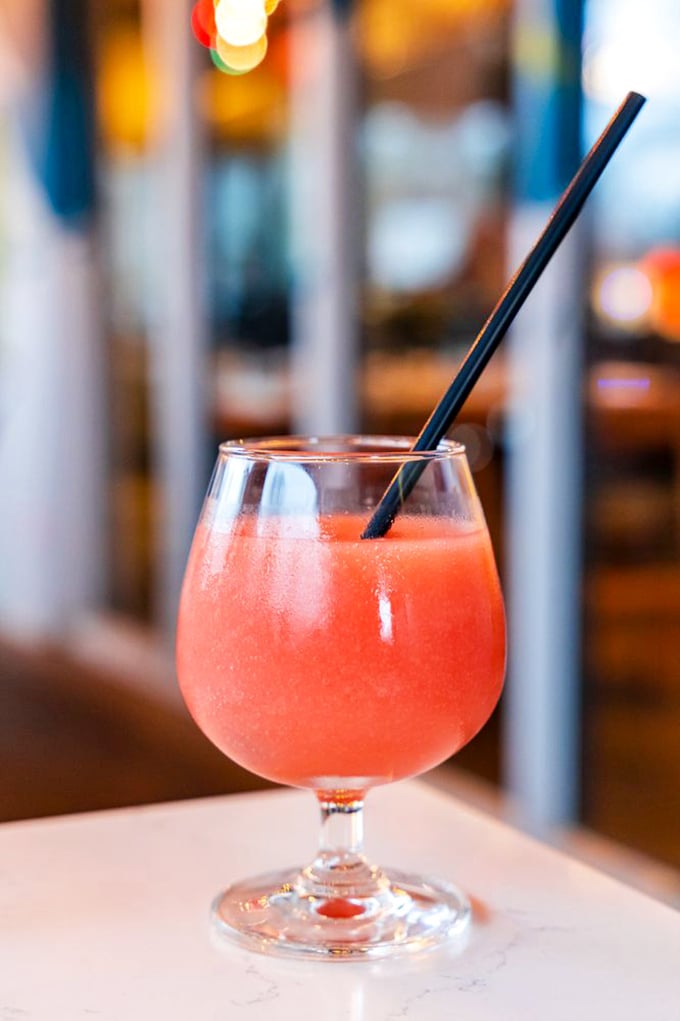 A sunset in a glass—this coral-hued cocktail promises refreshment with a side of sophistication, no beach vacation required.