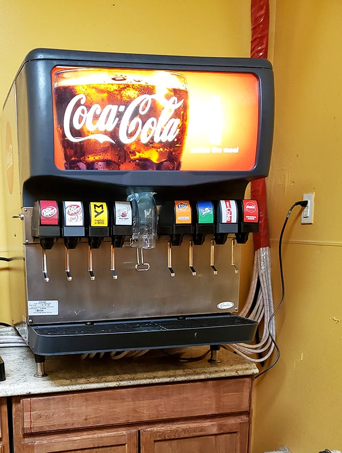 The soda fountain—where decisions about Coke versus Dr Pepper feel momentarily significant against the yellow wall that radiates warmth like Tennessee sunshine.