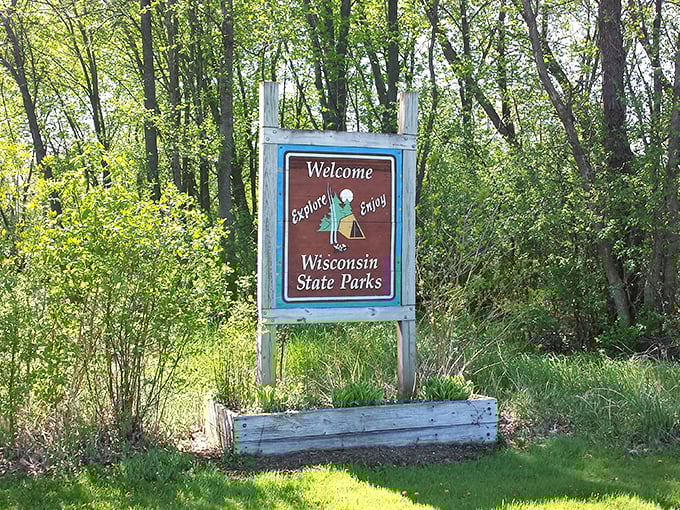 "Explore and Enjoy" isn't just a suggestion—it's practically a requirement when Wisconsin's natural treasures await beyond this welcoming sign.