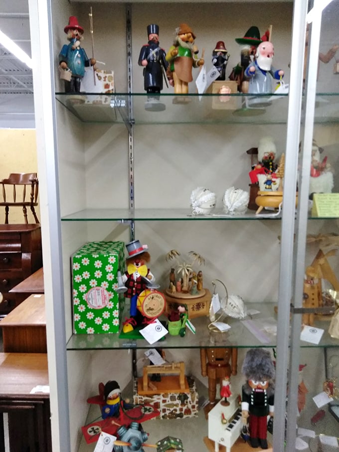 Wooden figurines stand guard over memories – each one a tiny ambassador from simpler times.