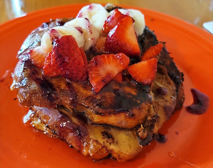 French toast that's clearly been to finishing school. Those fresh berries and syrup aren't just toppings—they're the supporting cast in a breakfast blockbuster.