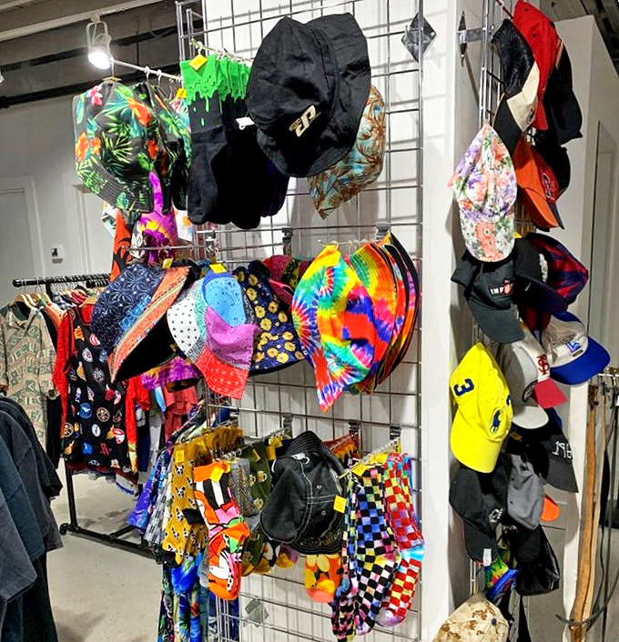 The hat display is a festival of personalities – from tie-dye bucket hats to structured caps, each one waiting to crown a new adventure.