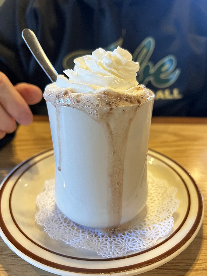 This hot chocolate doesn't just warm your hands – it's wearing a whipped cream hat so magnificent it deserves its own Instagram account.