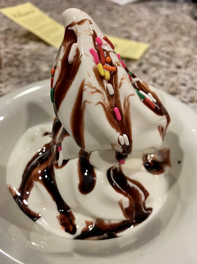 Soft-serve ice cream tower drizzled with chocolate and sprinkles – childhood nostalgia served at adult height with no one to tell you "that's enough."